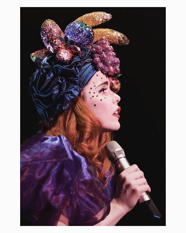 Singer Performing On Stage With Elaborate Costume