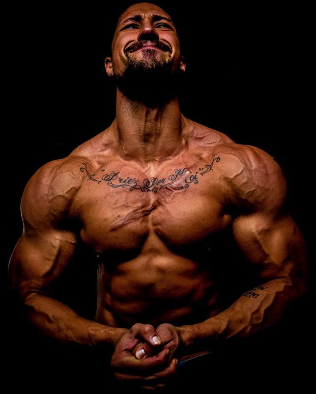 Muscular Bodybuilder Flexing Low Angle Studio